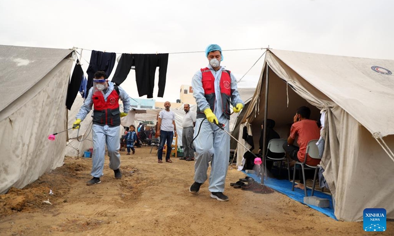 Staff workers disinfect temporary shelters in Gaza Strip - Global Times