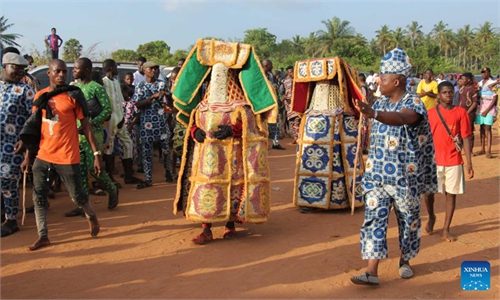 People in costumes perform mask dance in Benin - Global Times