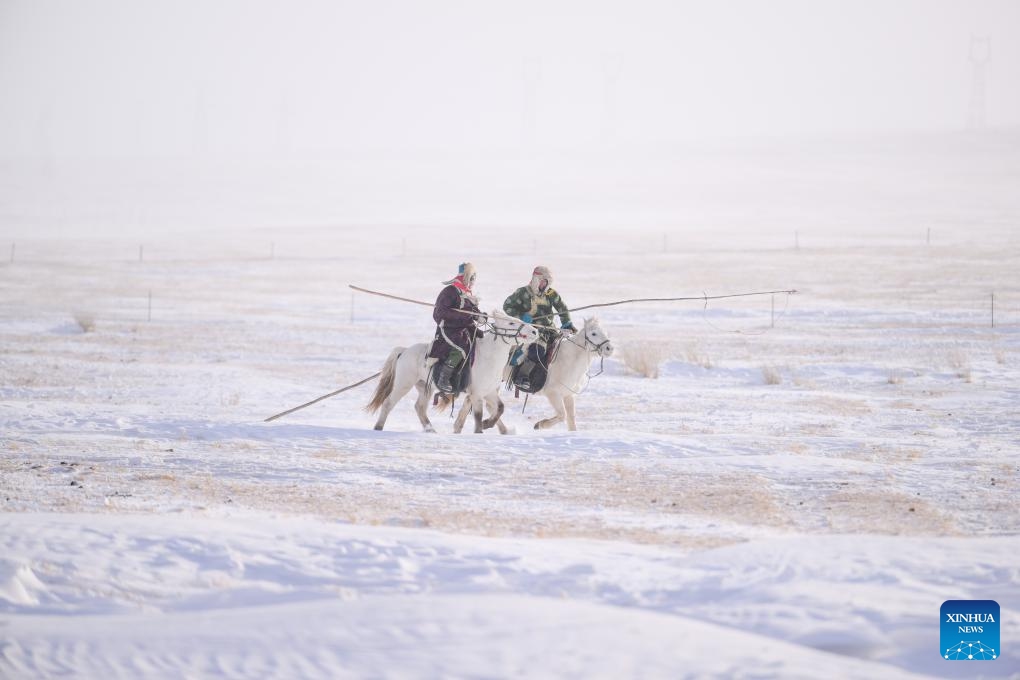Horsemen train horses on snow-covered grassland in China's Inner ...