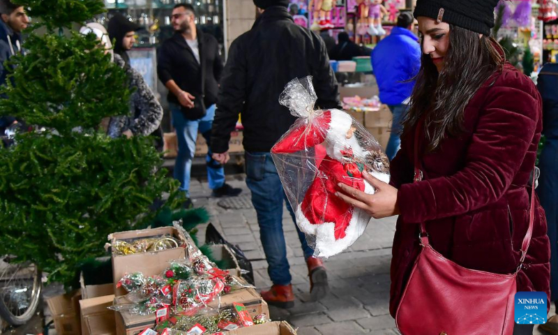 People seen at market of Christmas decorations in Damascus, Syria ...