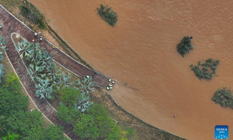 Workers clearing silt at riverside in Nanning, S China's Guangxi ...