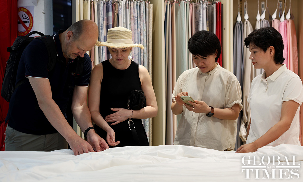 Textile market in Shanghai attracts foreign visitors seeking custom ...