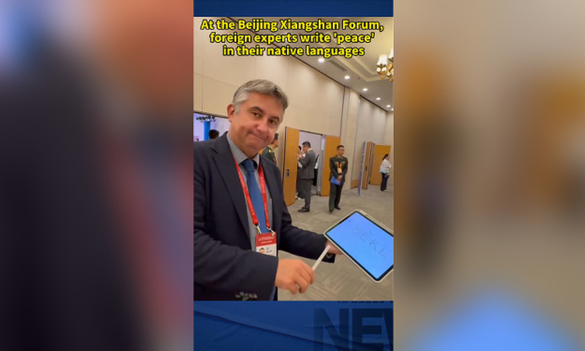 At the Beijing Xiangshan Forum, foreign experts write ‘peace’ in their ...